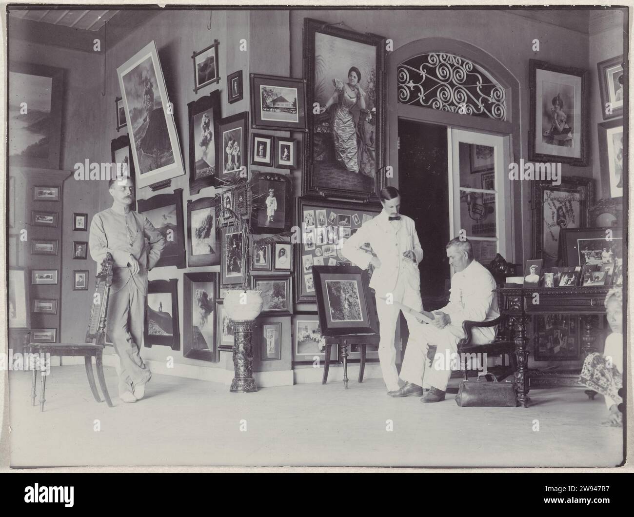 In the photo studio of Kurkdjian in Surabaya, 1900 - 1915 photograph Three unknown men view ...