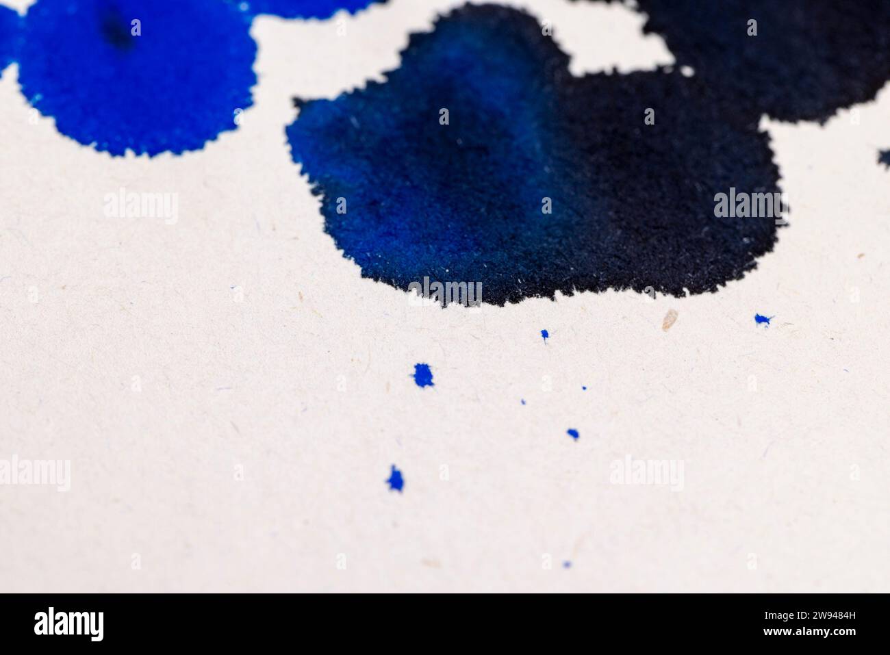 Black ink spatter on white paper hi-res stock photography and images ...