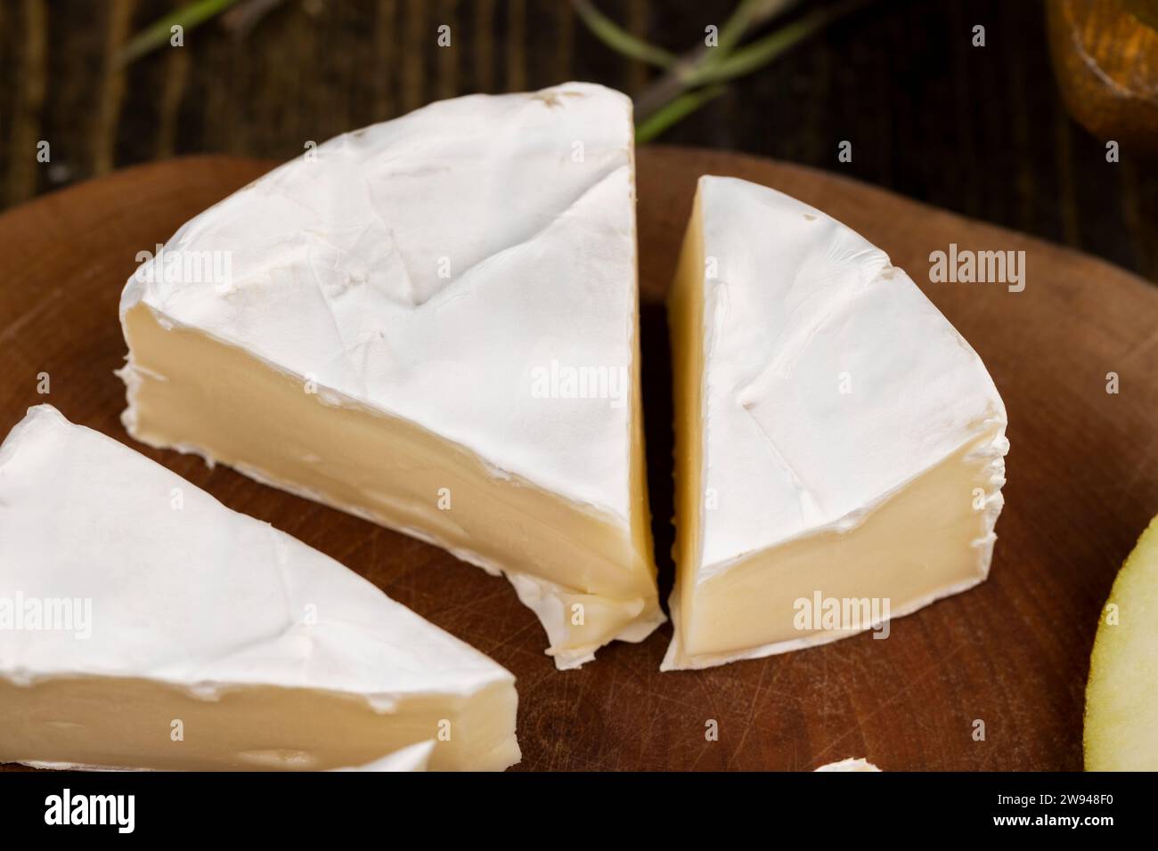 soft cheese with white mold on the board, fresh melted cheese with ...