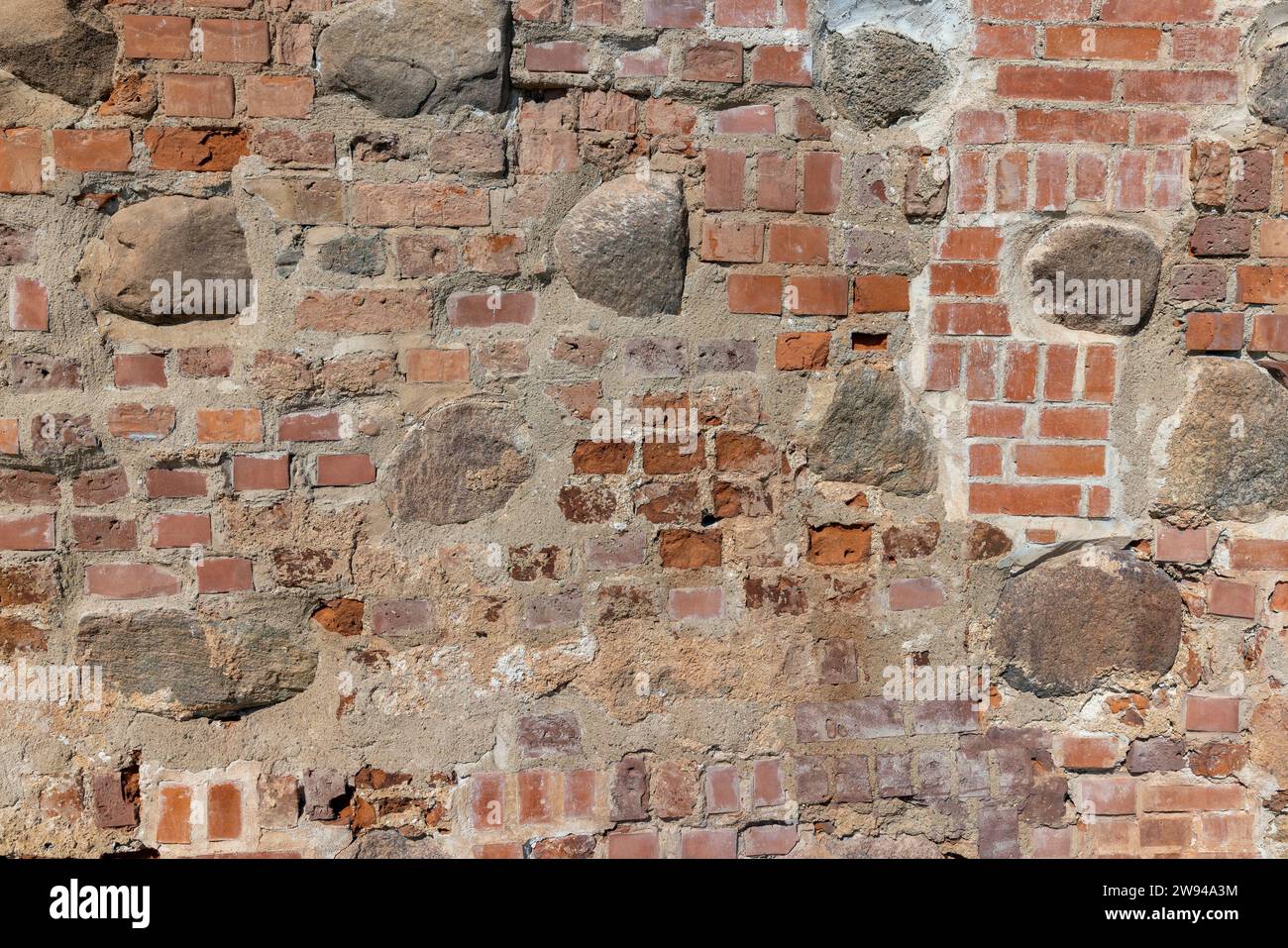 ancient wall of cobblestones and red bricks, combined ancient wall of ...