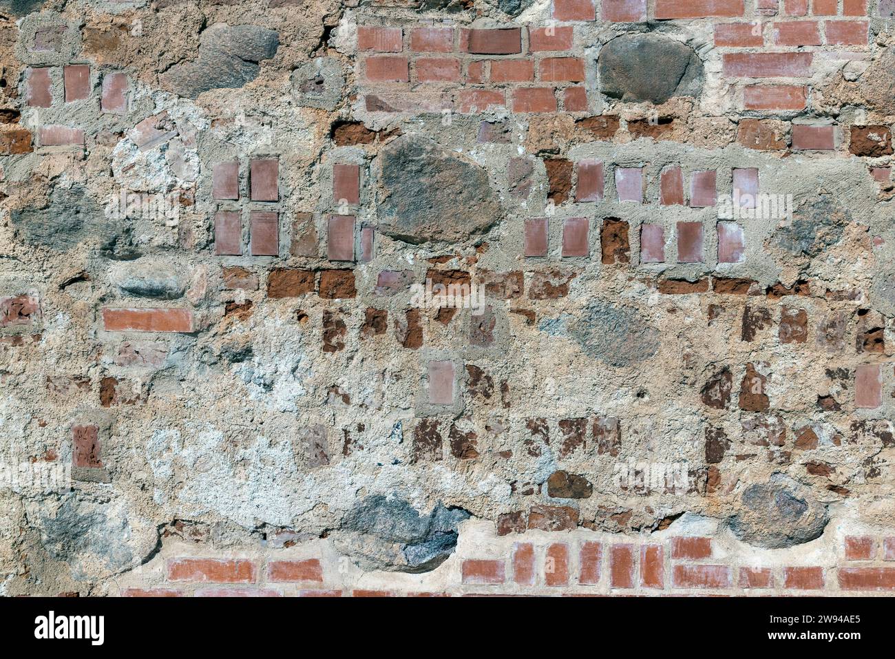 ancient wall of cobblestones and red bricks, combined ancient wall of ...