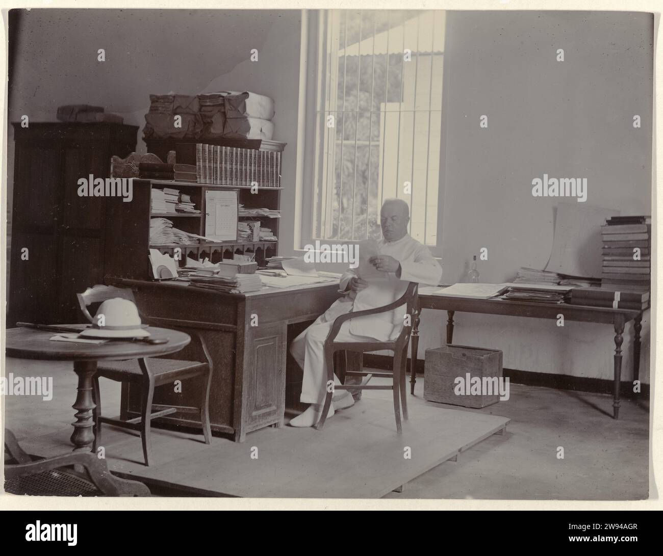 Man behind desk, 1898 photograph A man sitting behind his desk ...