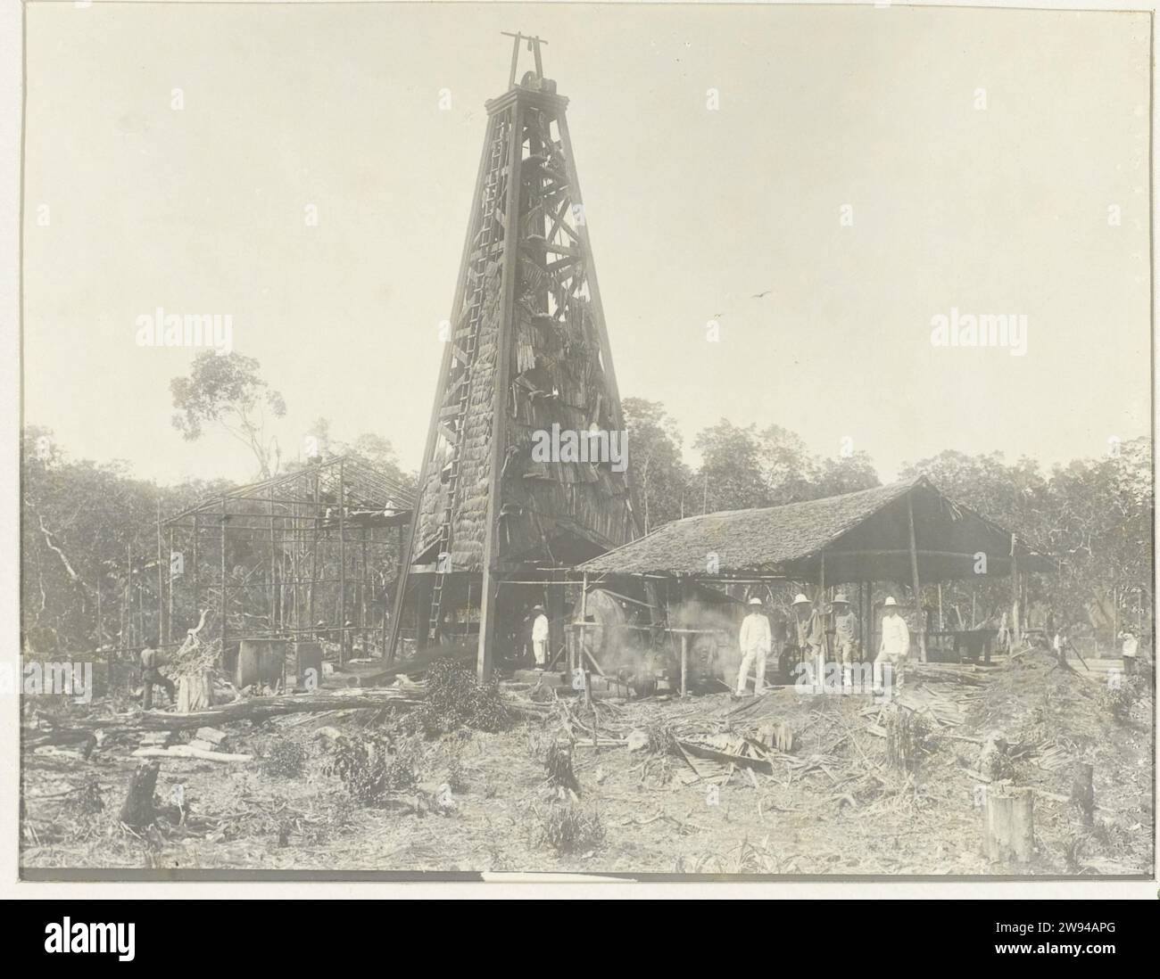 BOORTER Tower, 1903 - 1907 photograph A group of Europeans posing in front of a derrick partly ...