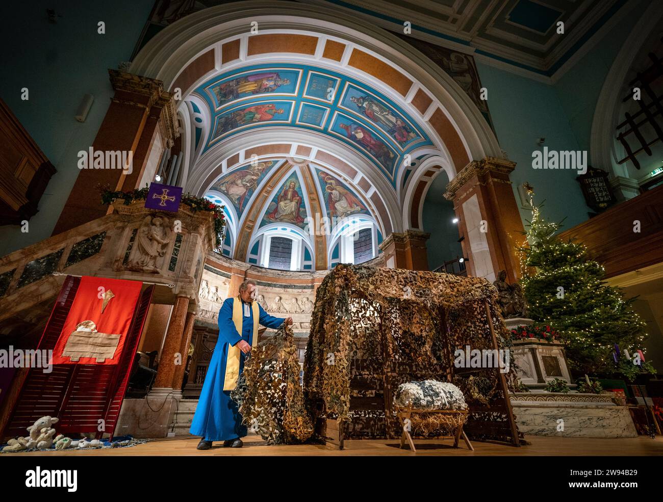 Parish minister Rev Peter Sutton stands alongside the nativity scene in ...
