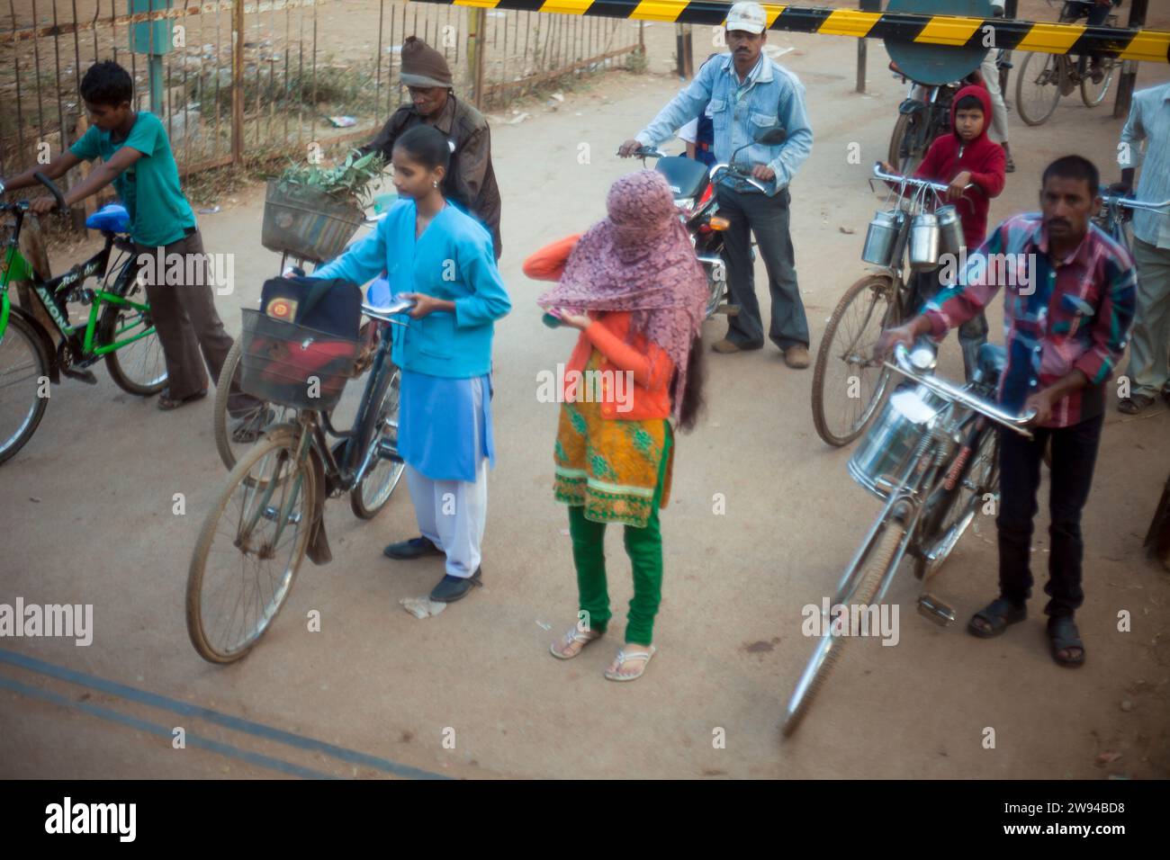 Local rural villagers of India standing at a Railway stop, the young ...