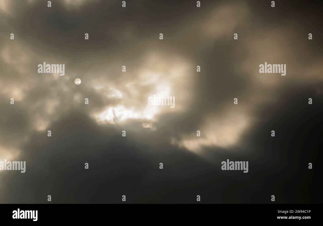 White Moon through dark clouds just before rains Stock Photo - Alamy