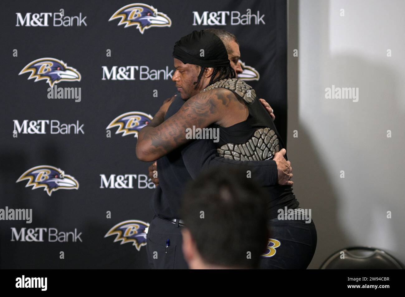 Baltimore Ravens quarterback Lamar Jackson hugs head coach John ...
