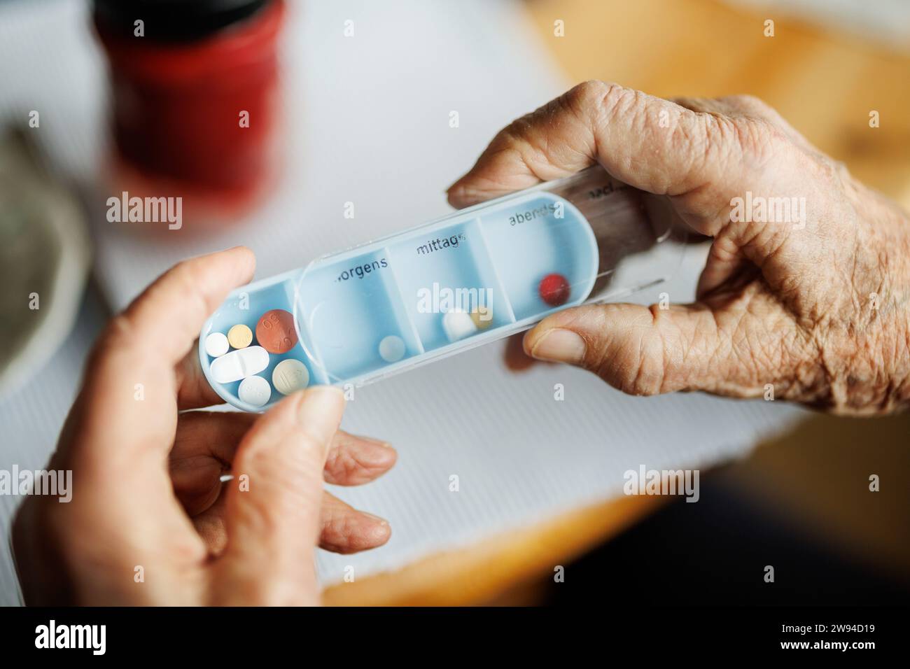 Norden, Germany. 23rd Dec, 2023. A lady over 90 years old takes a pill ...