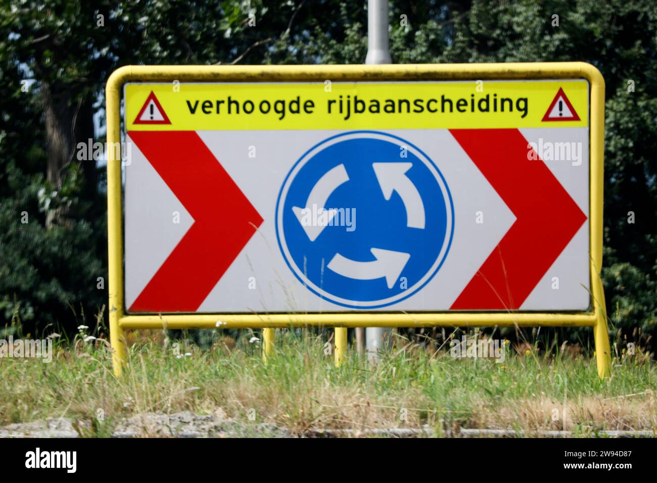 Sign for a roundabout and warning for Elevated lane separation in the ...