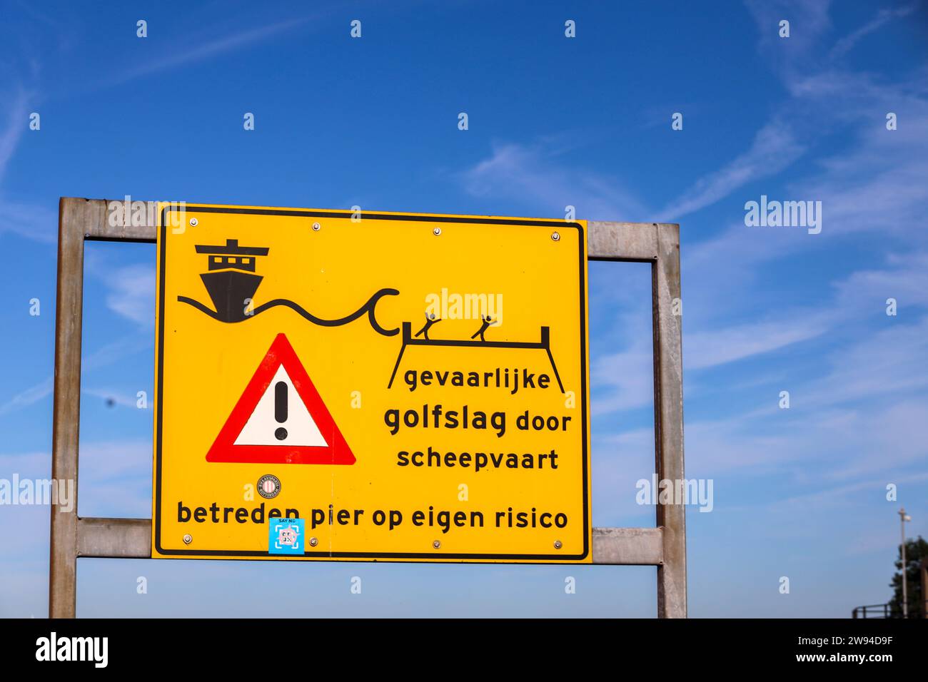 Yellow warning sign on Hoek van Holland pier for wave danger in ...