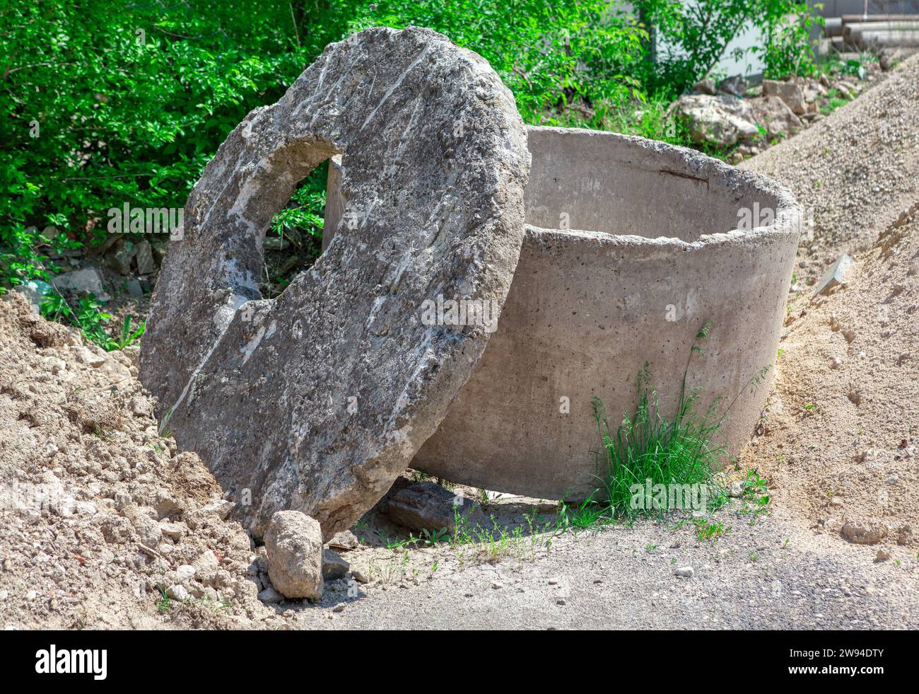 Concrete rings for installation of underground well Stock Photo - Alamy