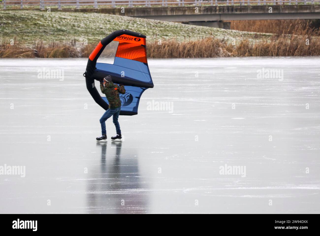 Surfing and kite surfing on skates on ice in the Eendragtspolder in the ...