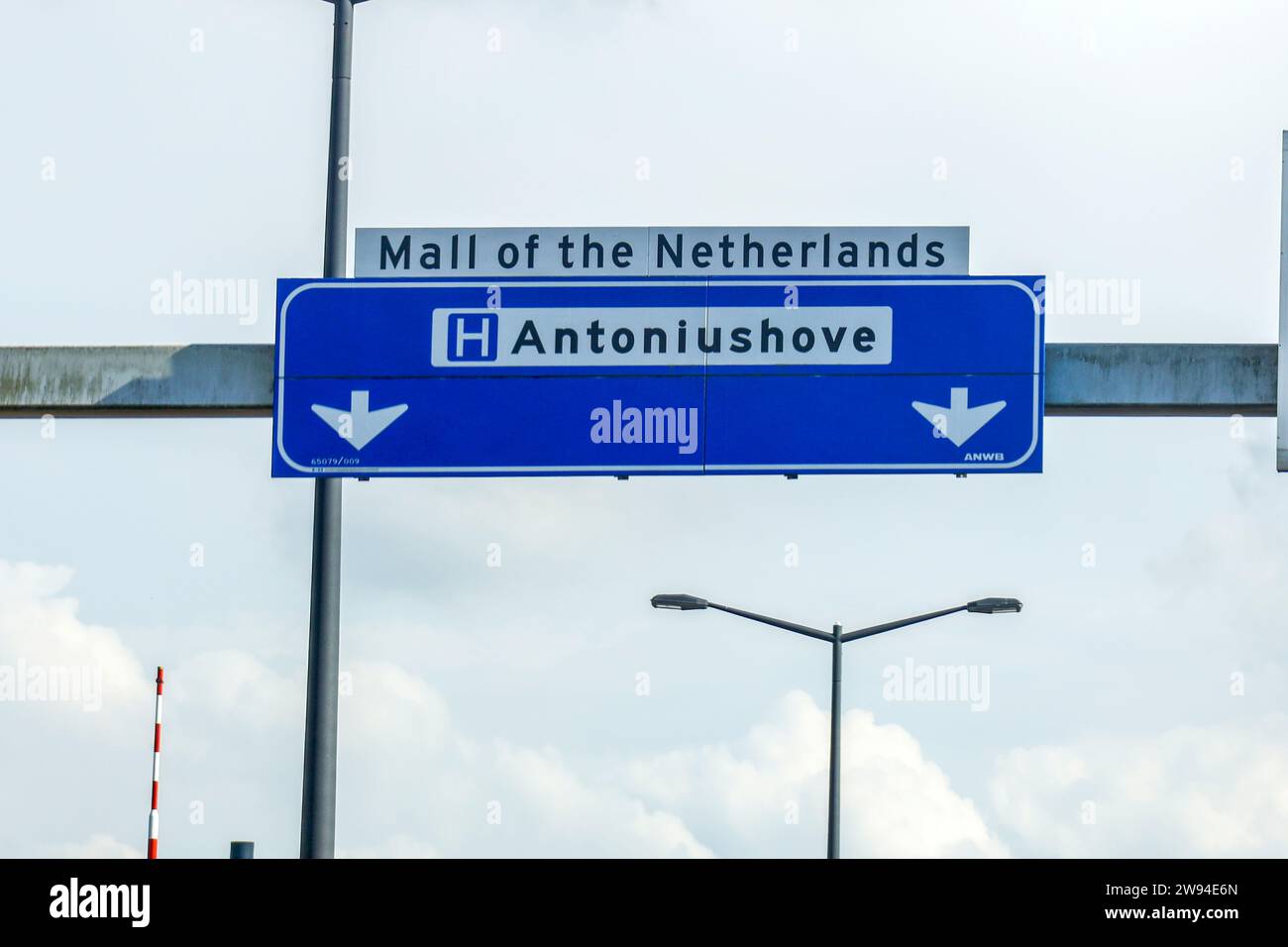 Blue and white directionsign to mall of the Netherlands and ...