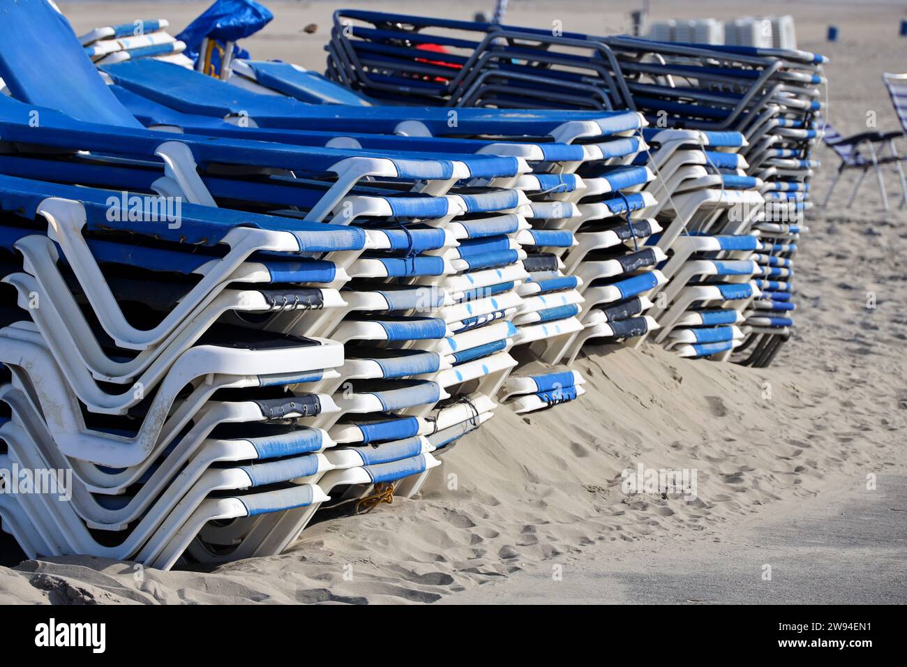 Stacked beach chairs wait for bathers at Hoek Van Holland beach in the ...