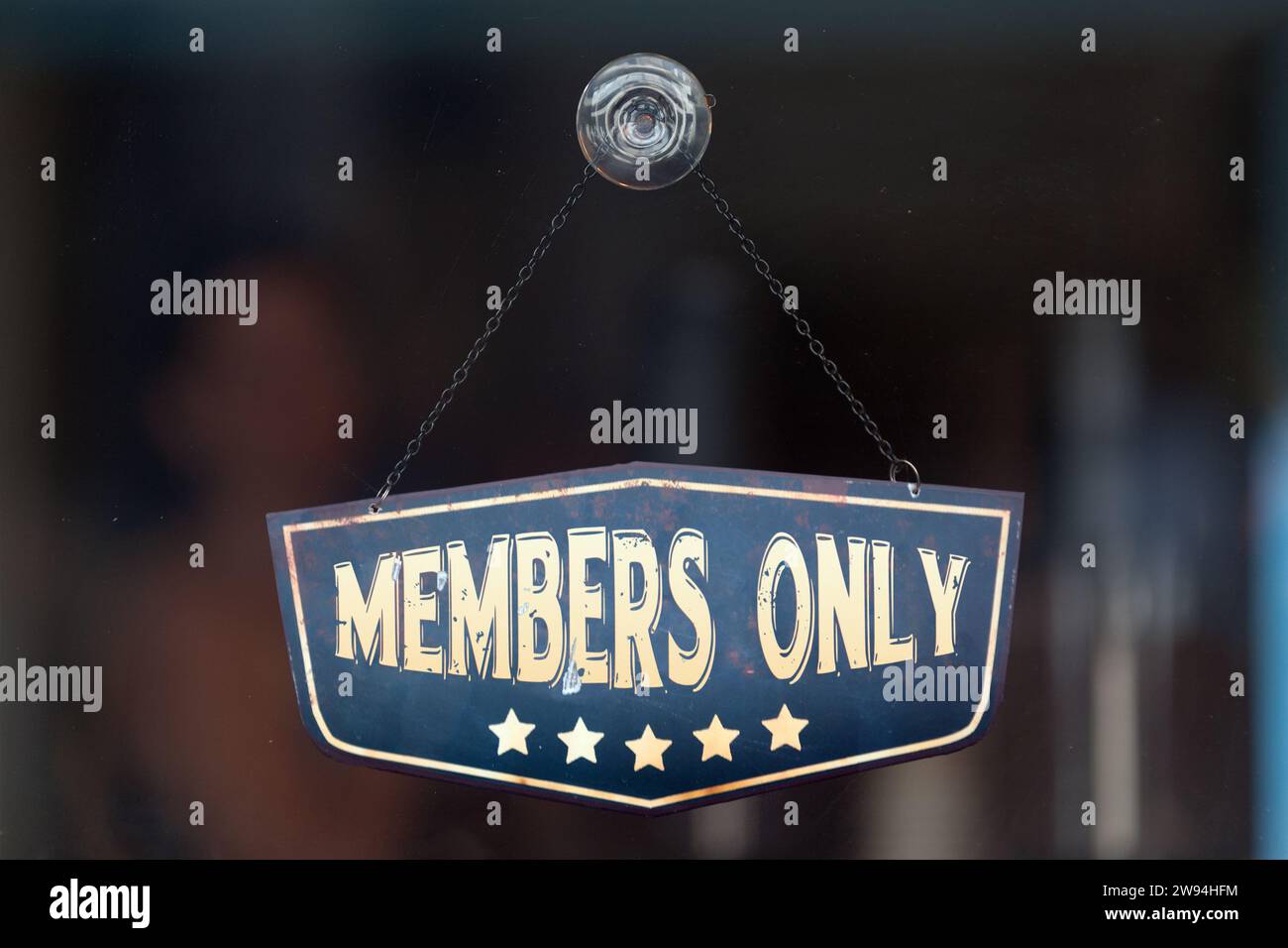 Old fashioned sign in the window of a shop saying in "Members only ...