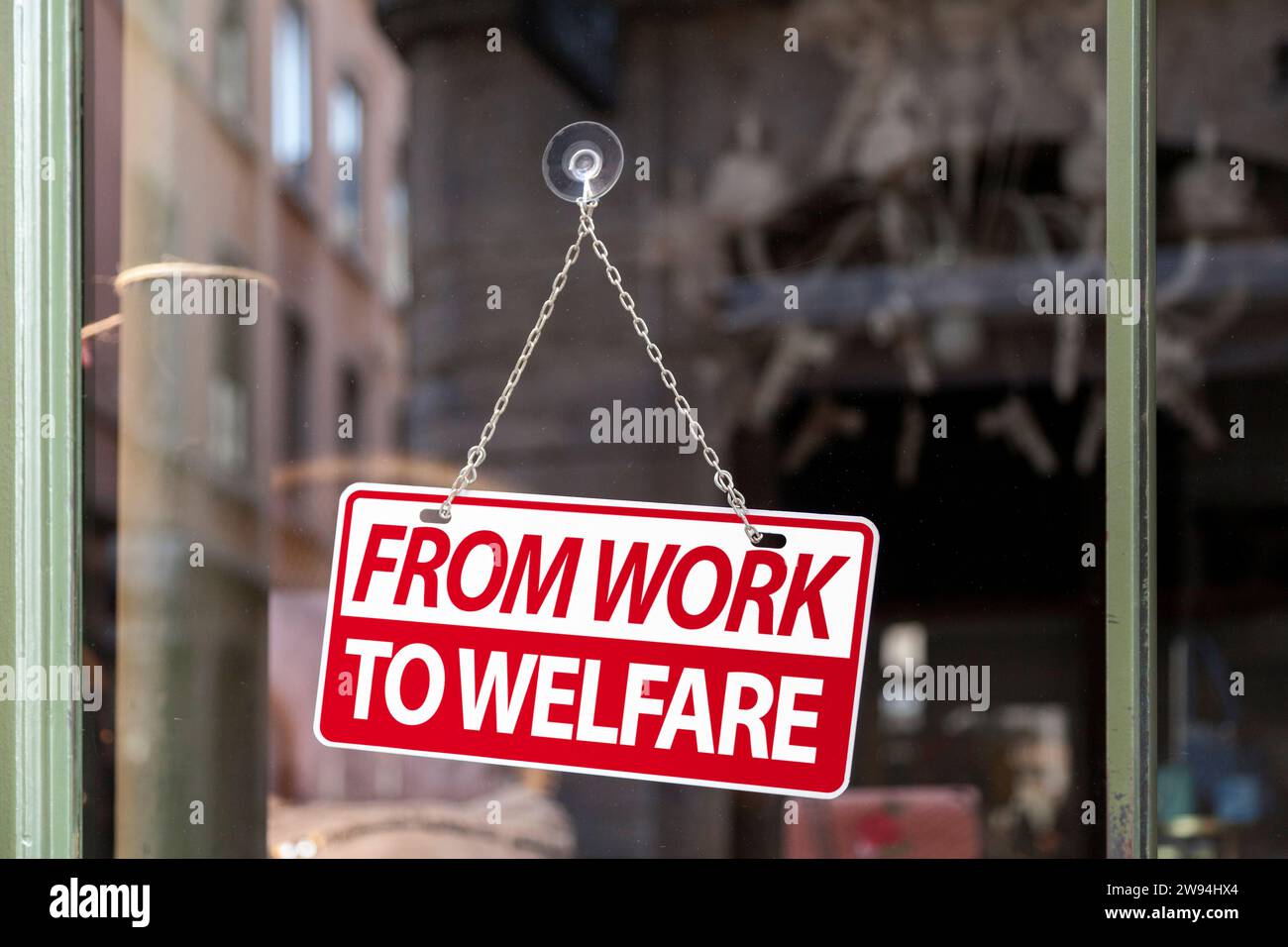 Close-up on a red and white sign in a window with written in "From work ...