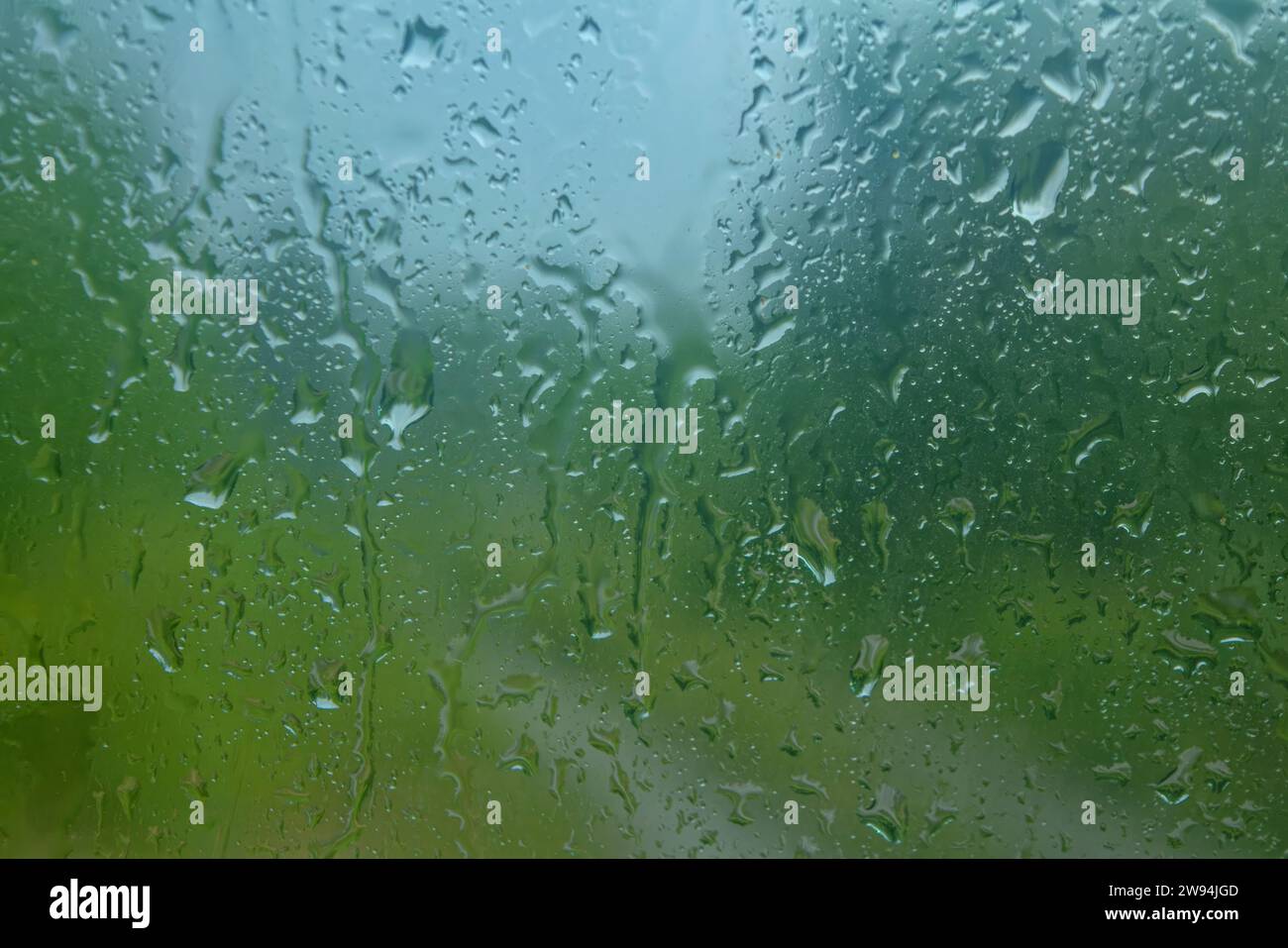 Rain drops on the window in rainy day. View from building. Nature ...