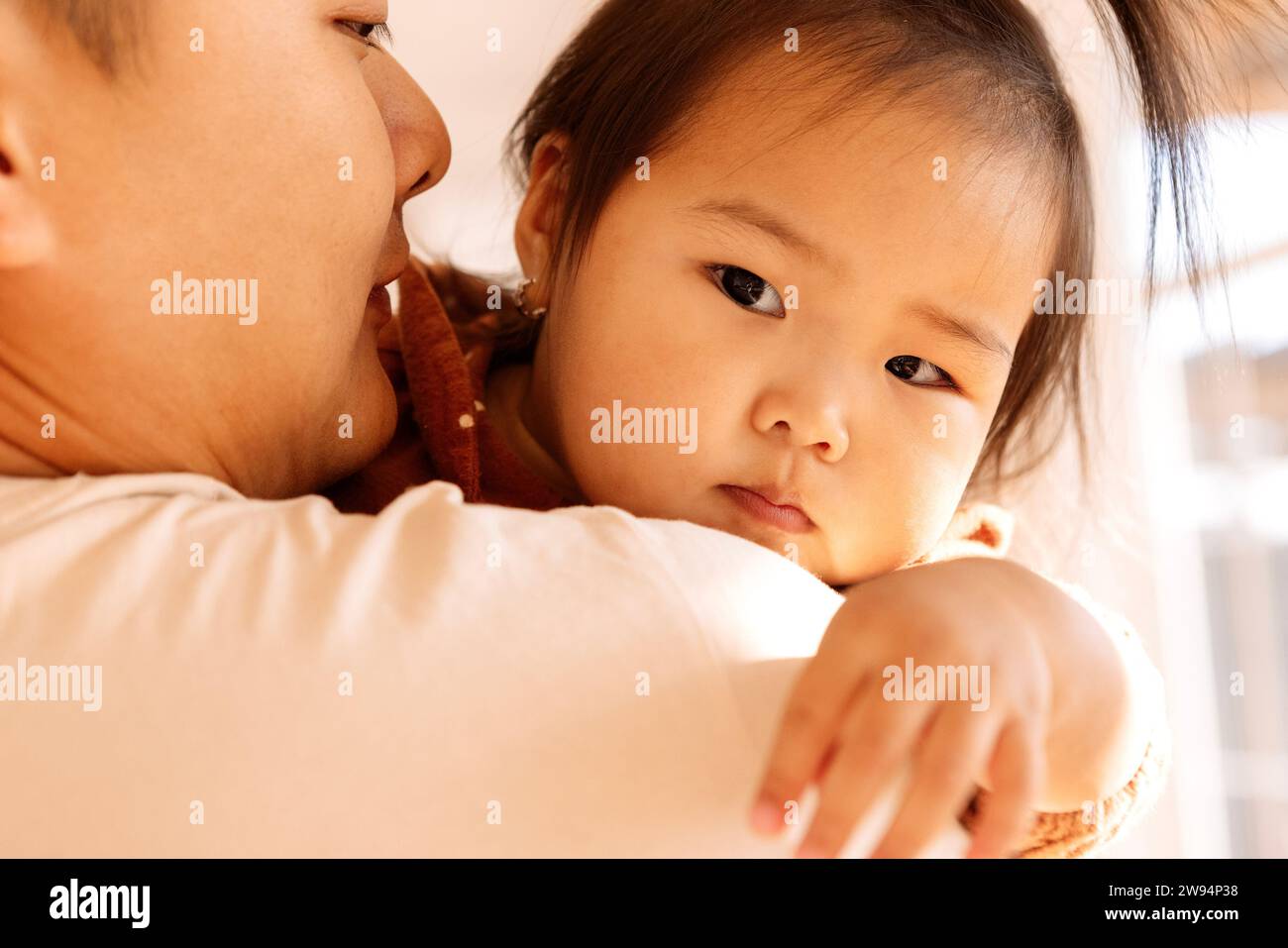 A close-up portrait of an Asian little girl and her dad. A young Korean ...