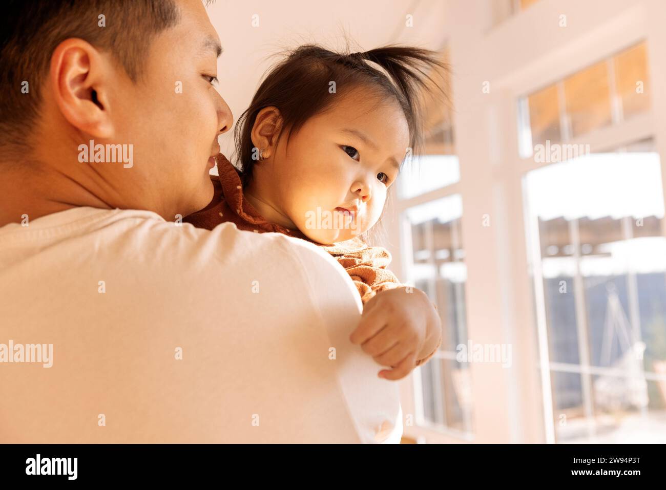 A close-up portrait of an Asian little girl and her dad. A young Korean ...