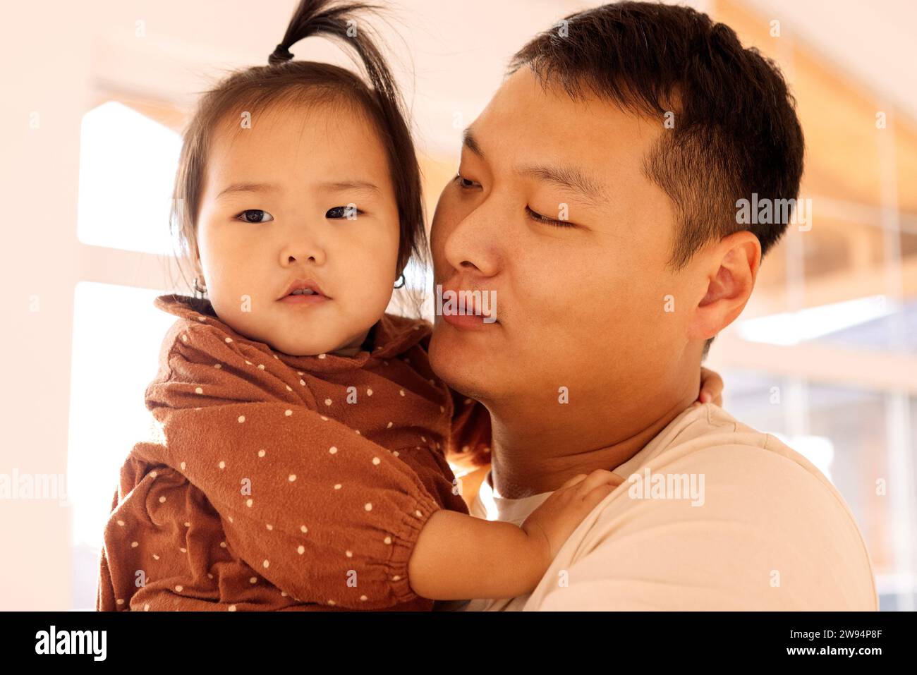 Asian family of dad and daughter hugging indoors Stock Photo - Alamy