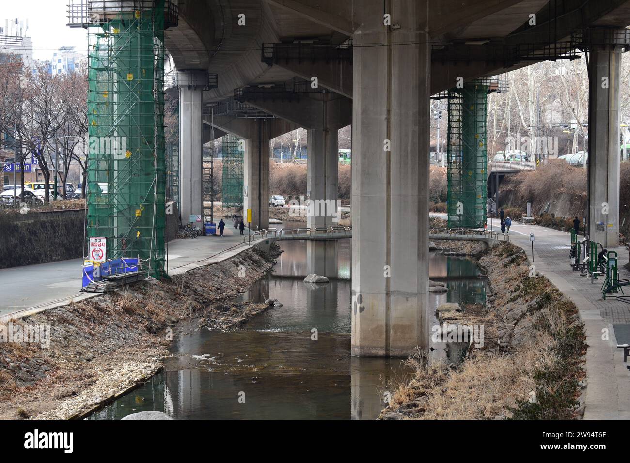 Small urban canal flowing underneath an elevated highway in Seodaemun ...