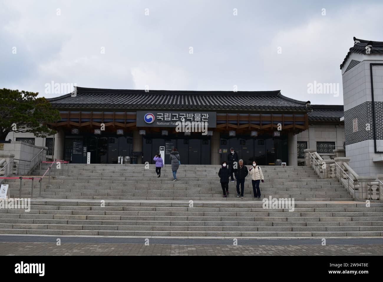 People walking on the stone stairs leading to the main entrance of the ...