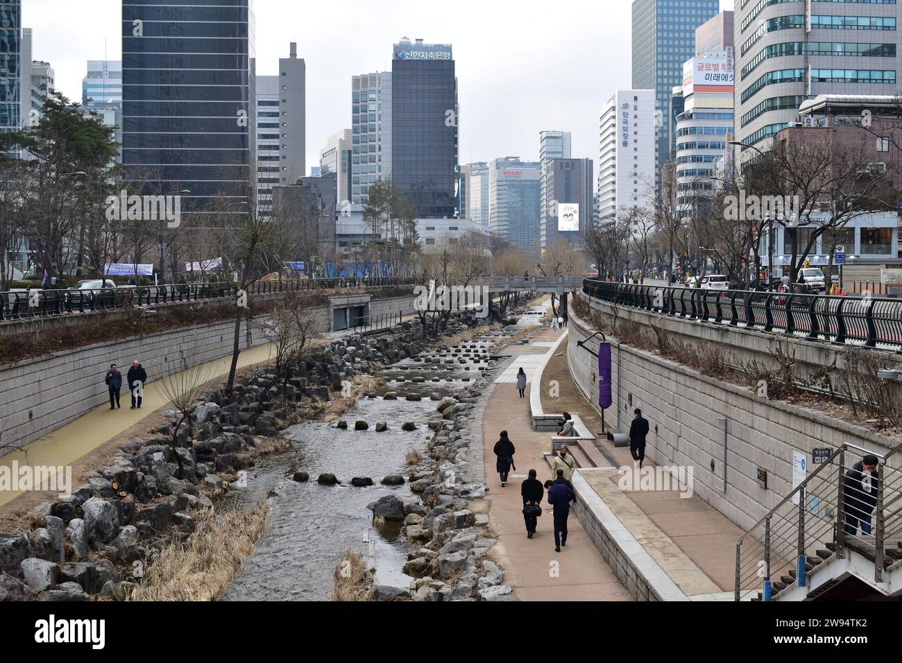 People walking in Cheonggyecheon park, an open water stream in downtown ...