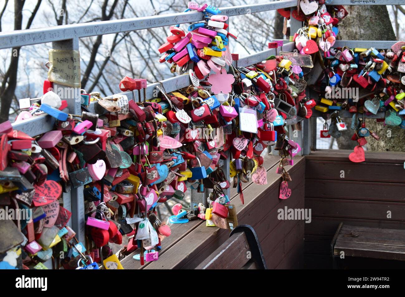 Colorful love locks with couples' names written on them, attached to ...