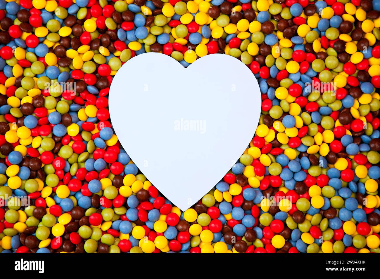 Heart shape inside smarties Stock Photo - Alamy