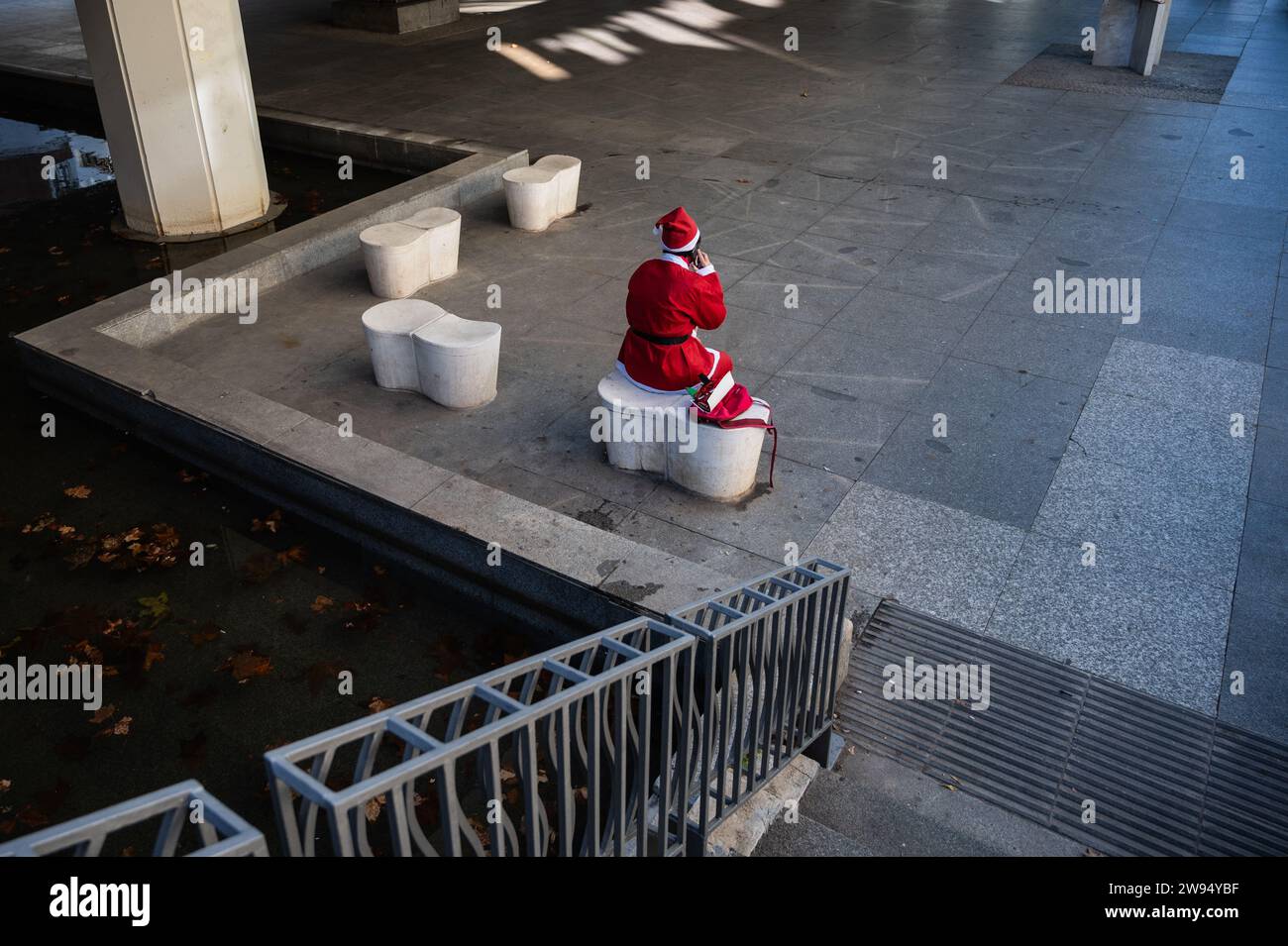 Madrid, Spain. 24th Dec, 2023. A man dressed as Santa Claus speaking ...
