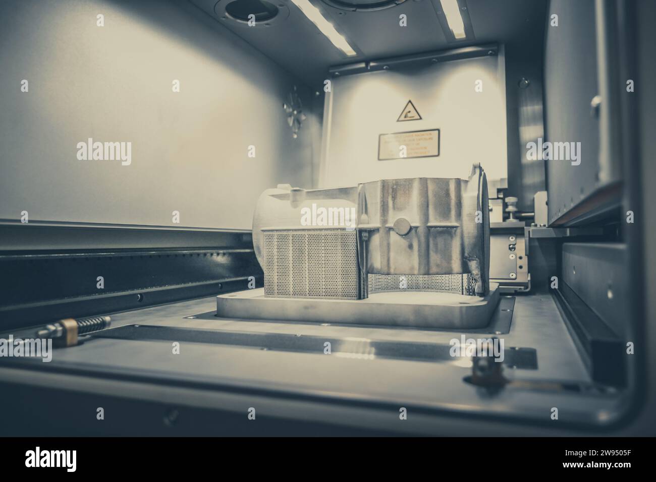 A model with supports created in a laser sintering machine stays in the ...