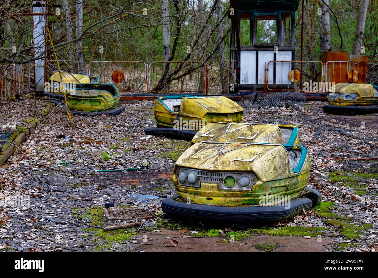 An old, dilapidated bumper car with peeling paint, showing signs of ...