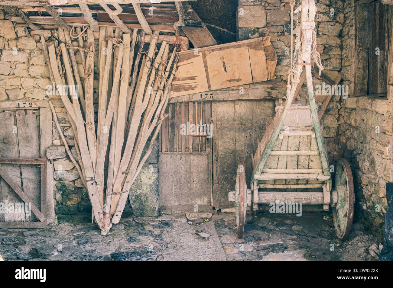 An abandoned wooden wheelbarrow inside a old barn (Spain Stock Photo ...