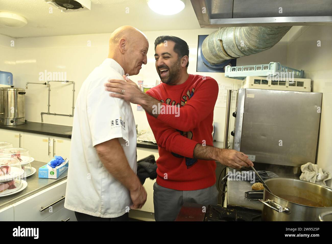 First Minister of Scotland Humza Yousaf chef Gary Melvin as he serves ...