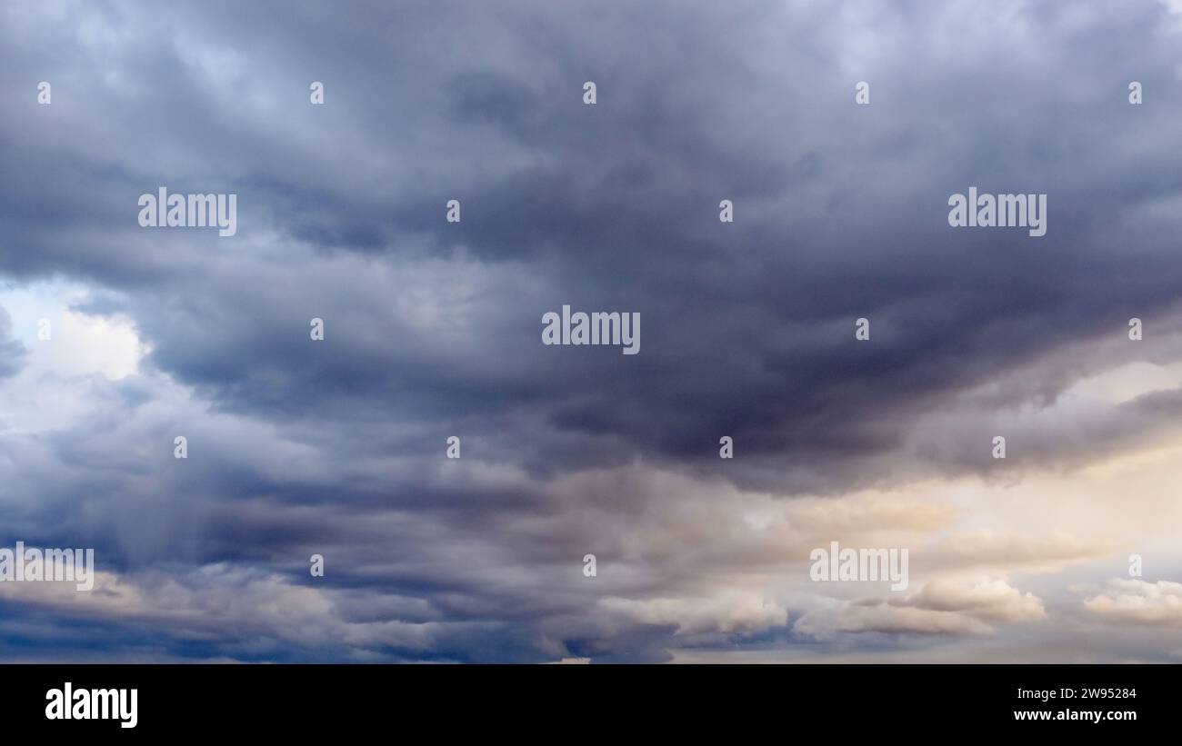 The image shows dark, ominous clouds covering the sky, indicating an ...