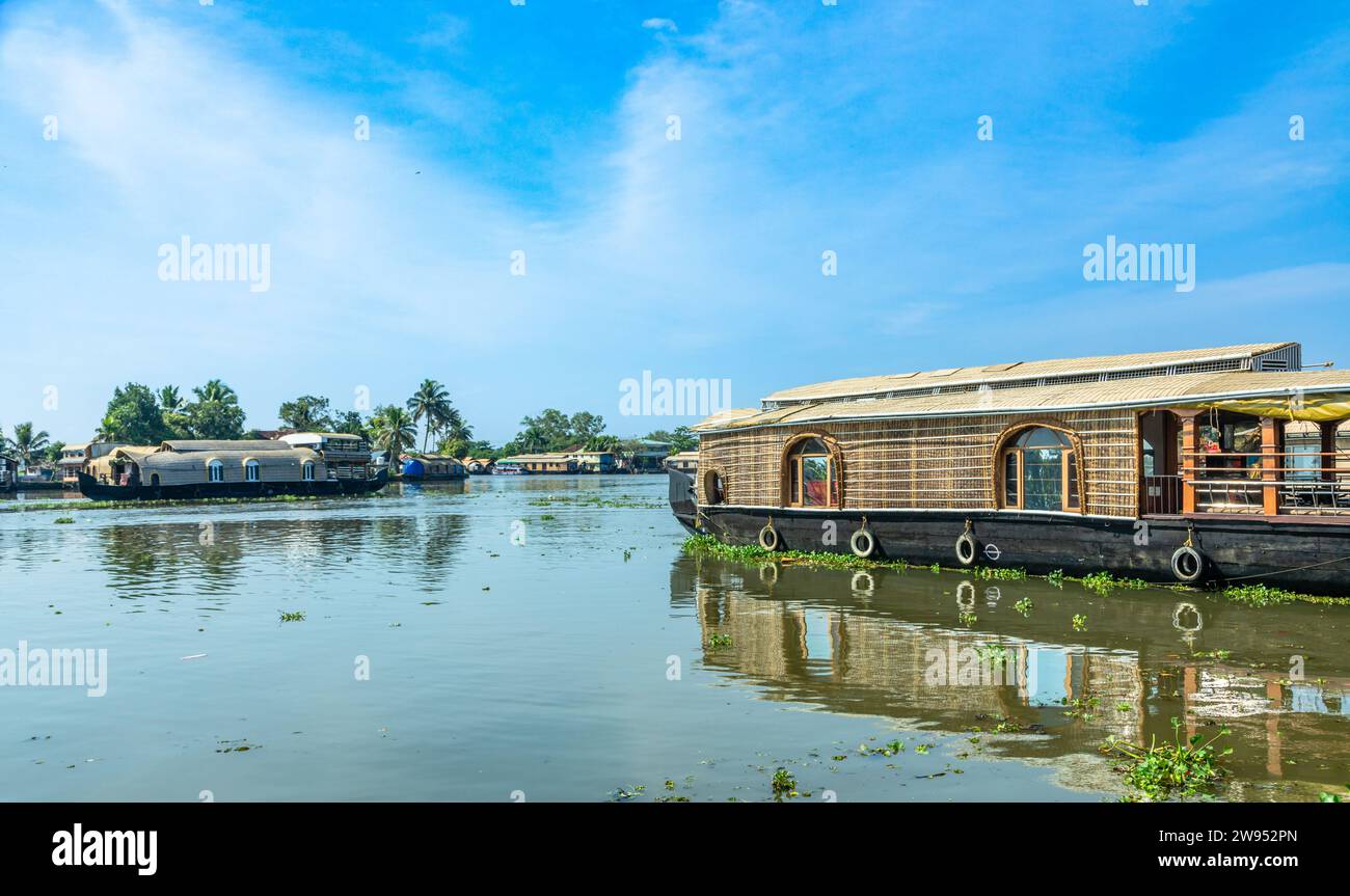Indian traditional houseboats floating on Pamba river, with palms at ...