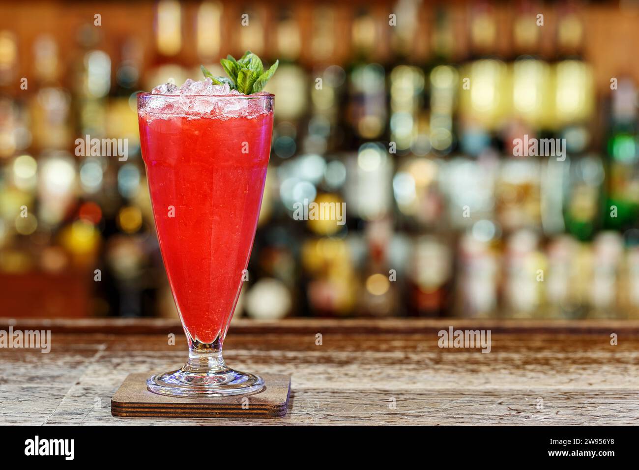 Cocktail mint berry on the bar, on a blurry bar background, space for ...