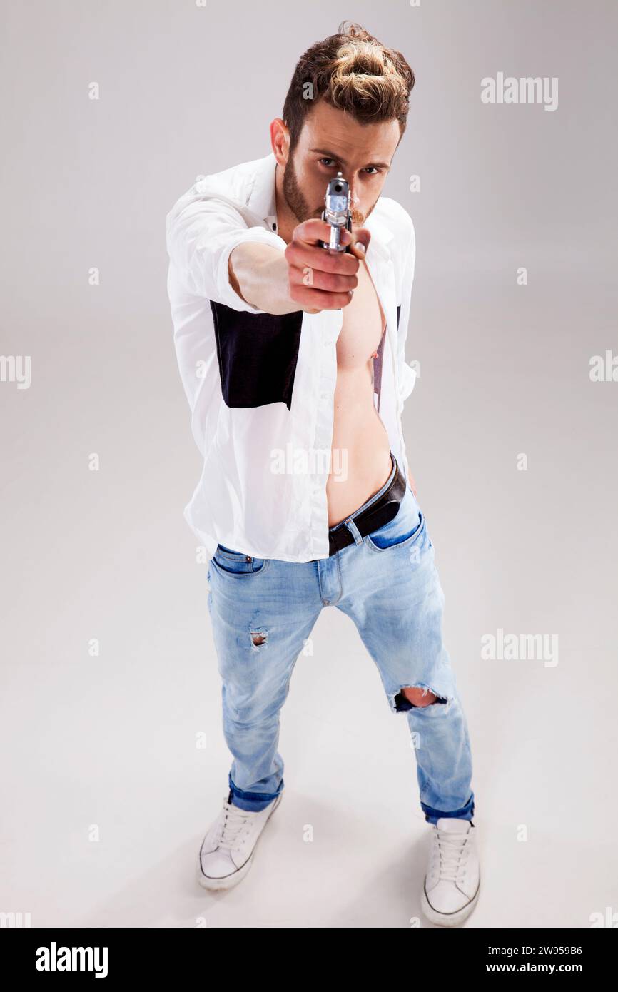Handsome young man aiming gun hi-res stock photography and images - Alamy
