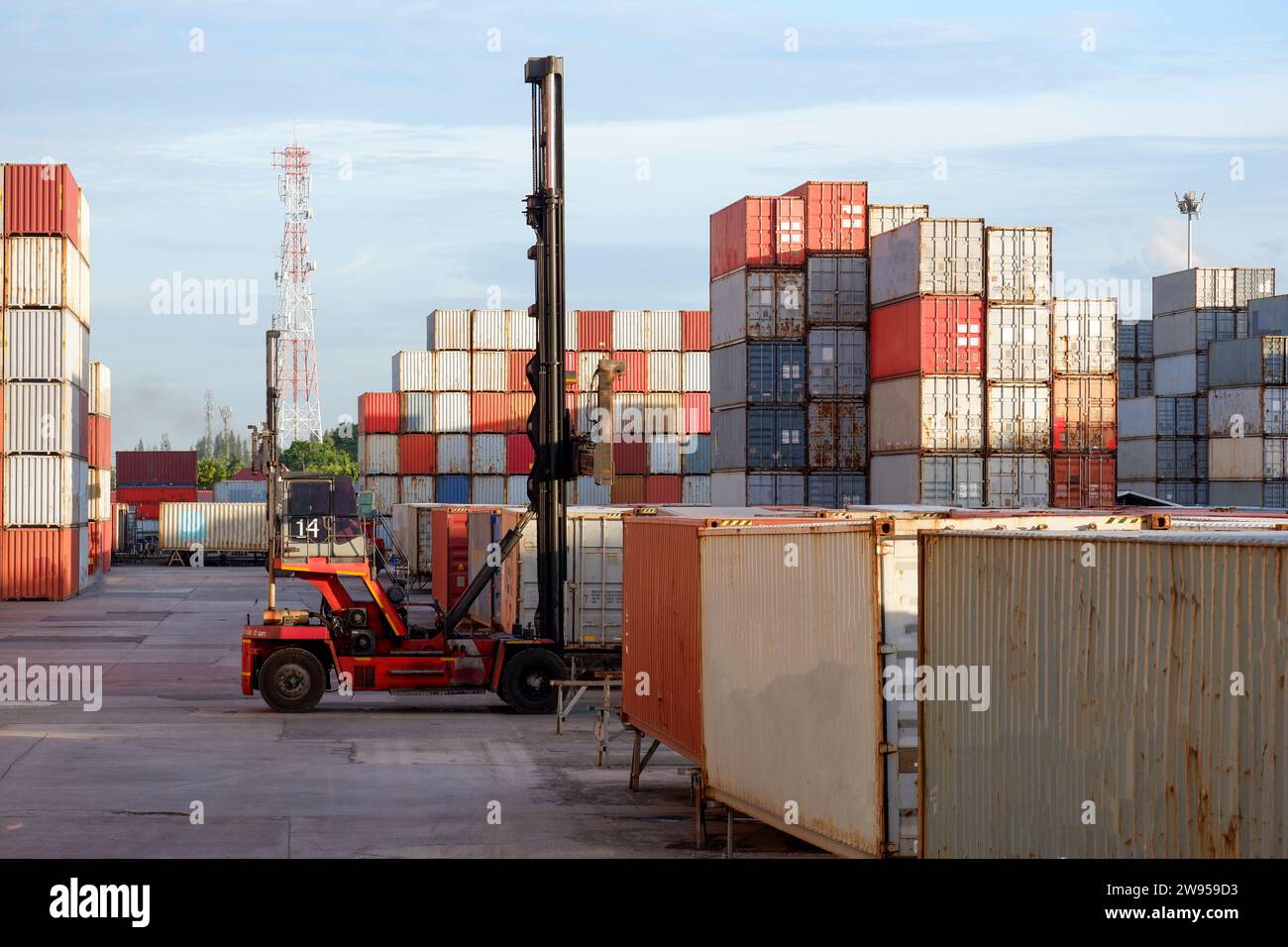 Forklift handling goods, container boxes in logistics yard with stack ...