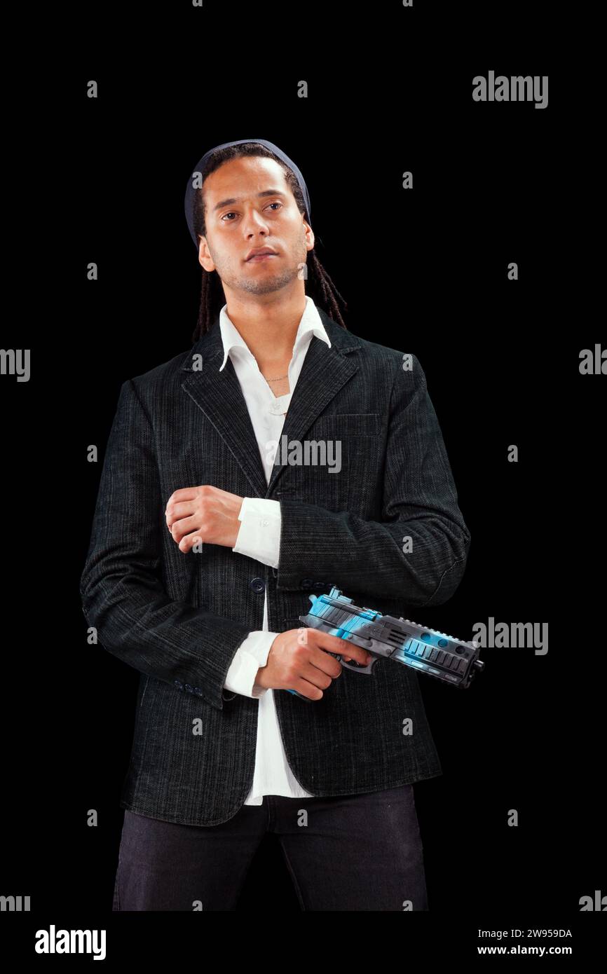 Powerful young man with a gun Stock Photo - Alamy