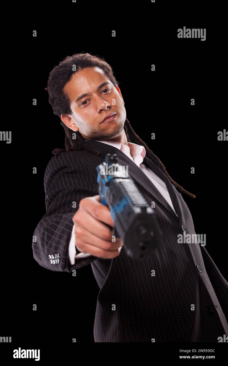 Powerful young man with a gun Stock Photo - Alamy