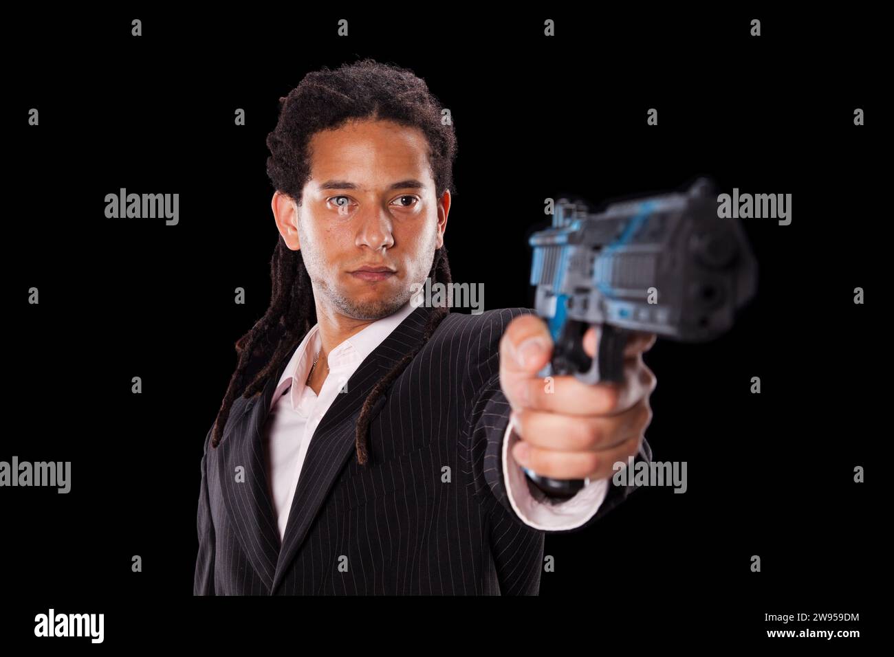 Powerful young man with a gun Stock Photo - Alamy