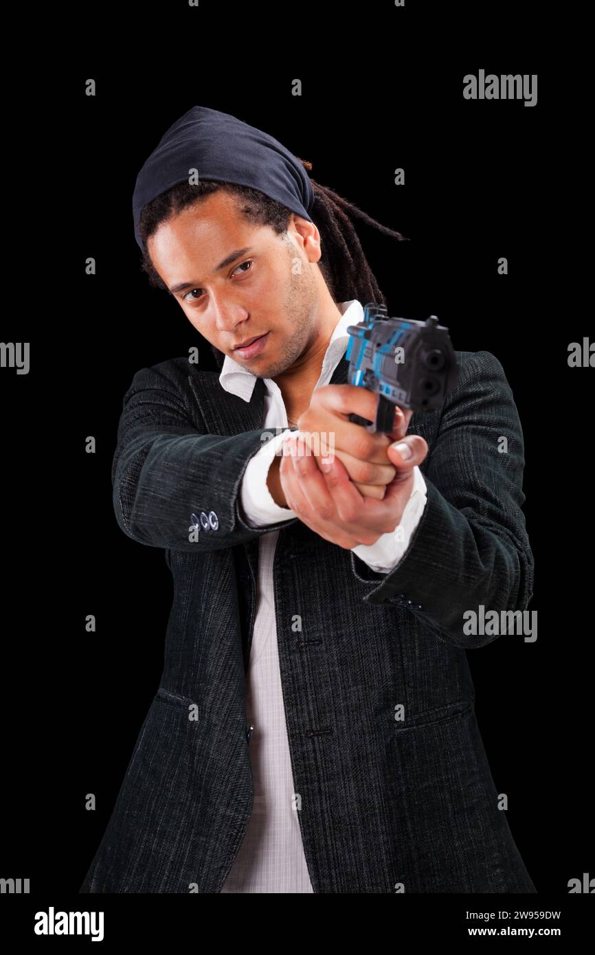 Powerful young man with a gun Stock Photo - Alamy