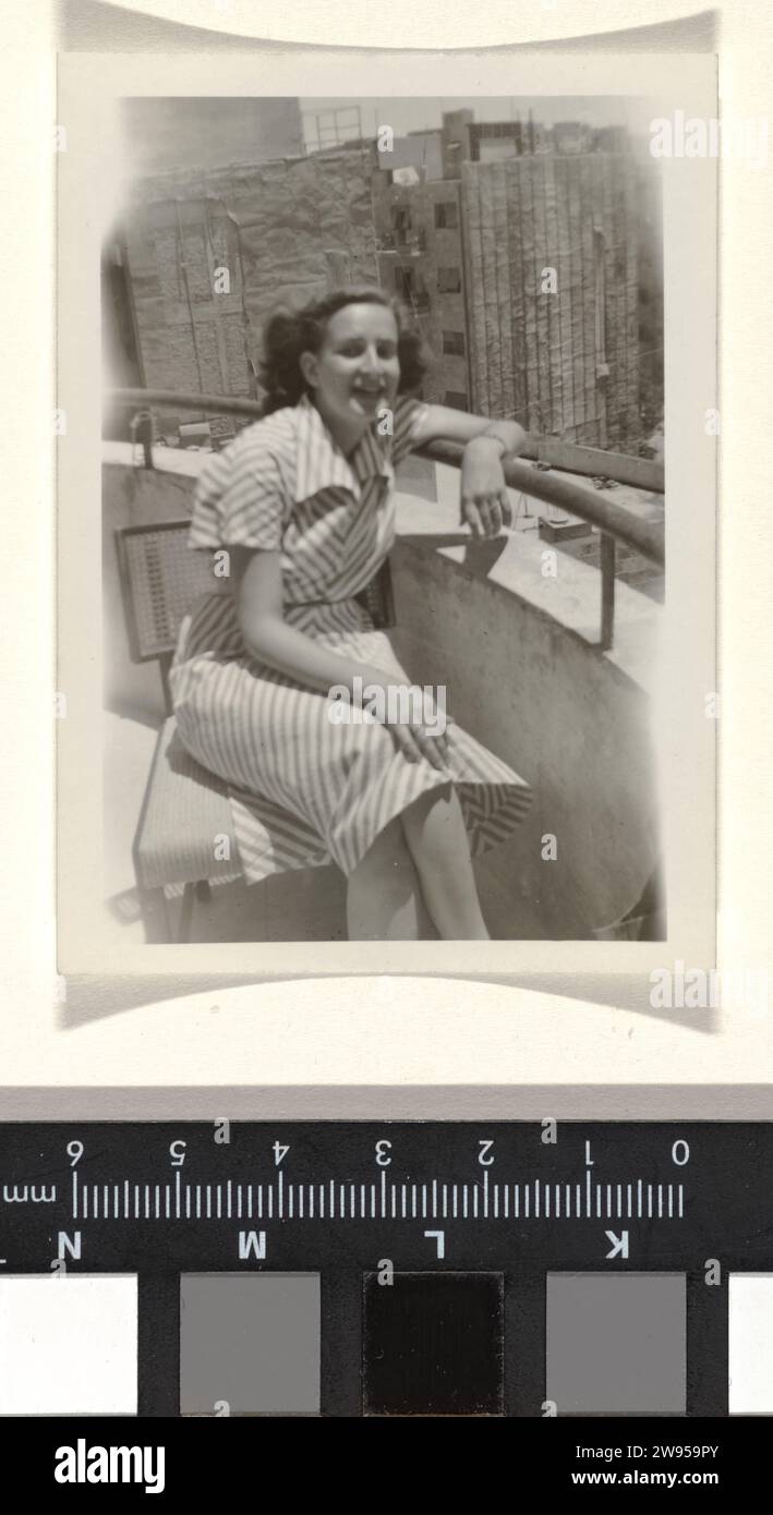 Isabel Wachenheimer in dress with motif of striped jobs, sitting on a chair with her arm on the ...