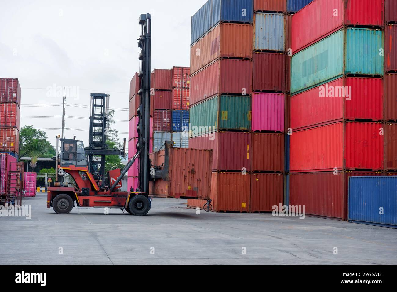 Crane lifts container boxes onto truck in import-export logistics zone ...