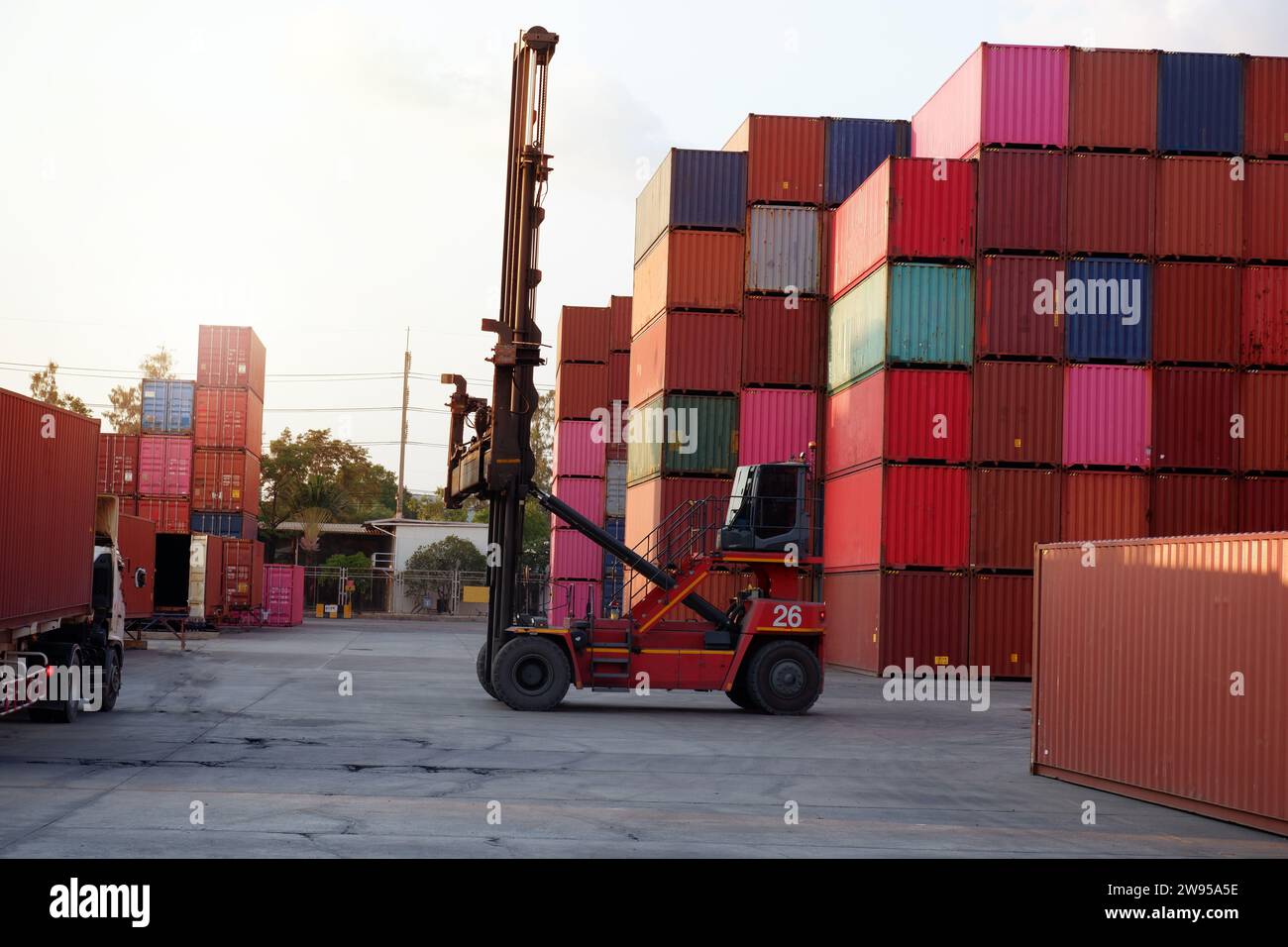 A truck lifts a container onto a truck in the import-export logistics ...