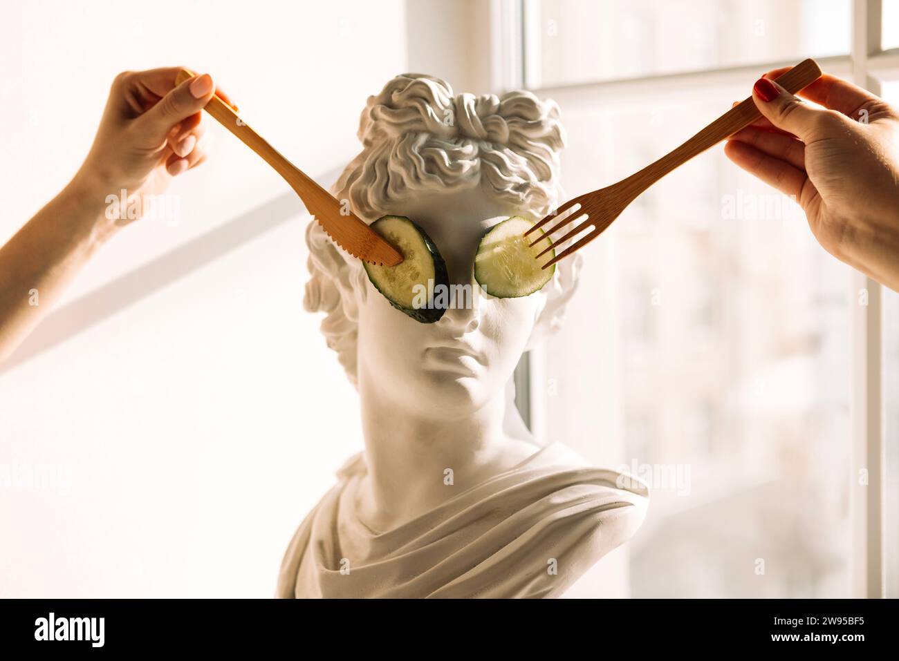 A plaster copy of an antique bust of a young man with cucumber slices ...