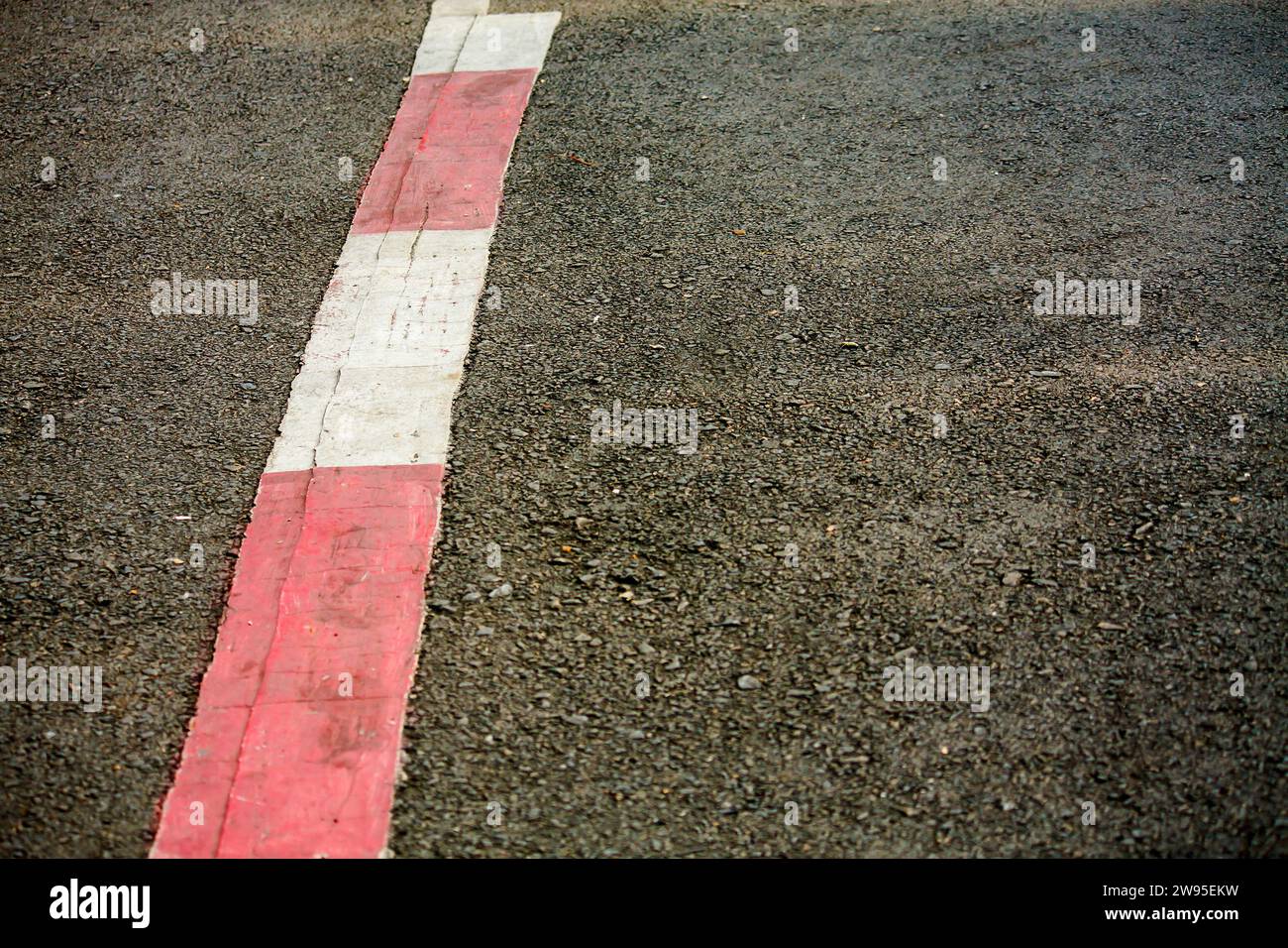 asphalt texture with red and white line marking Stock Photo - Alamy