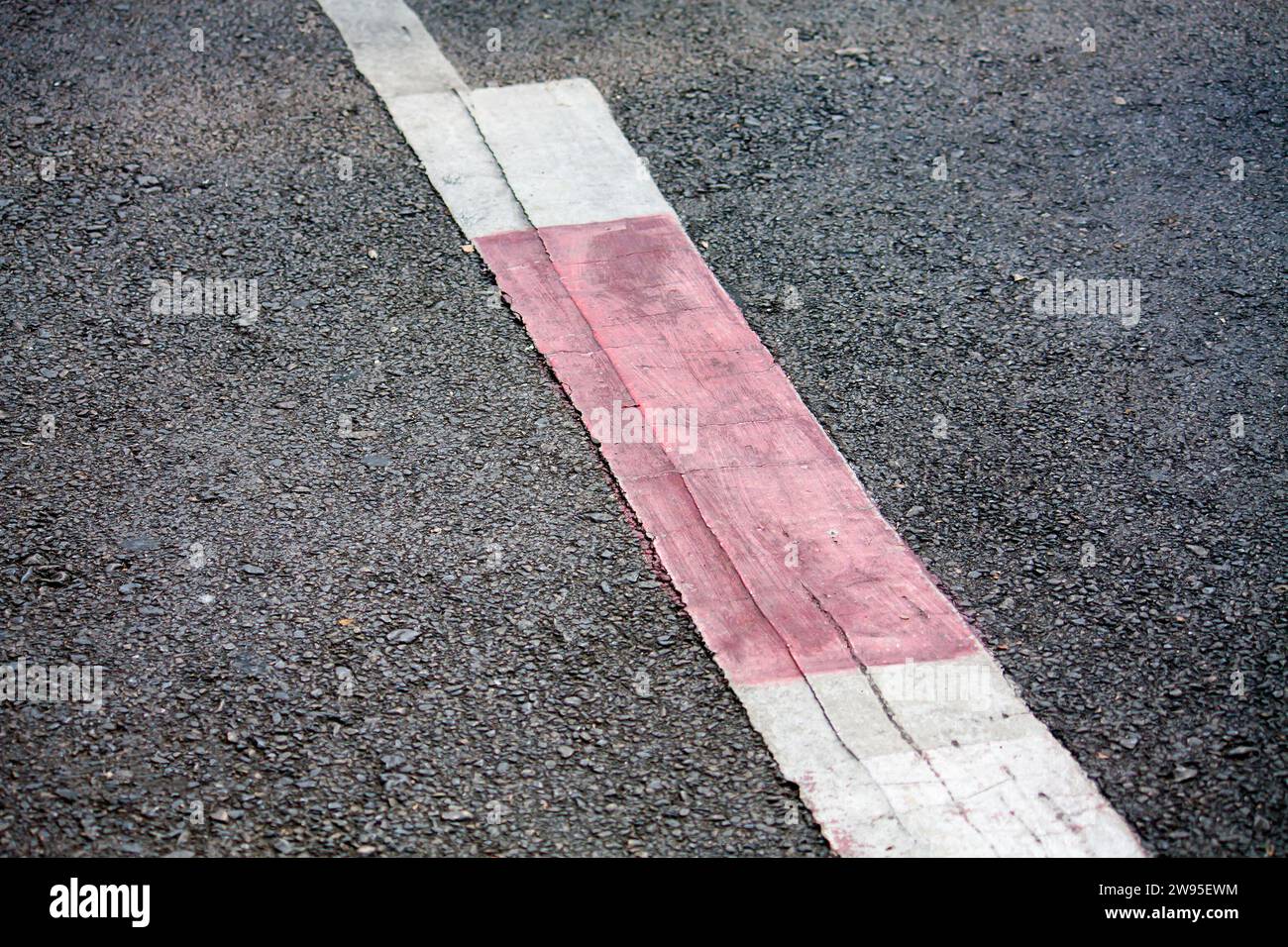 asphalt texture with red and white line marking Stock Photo - Alamy