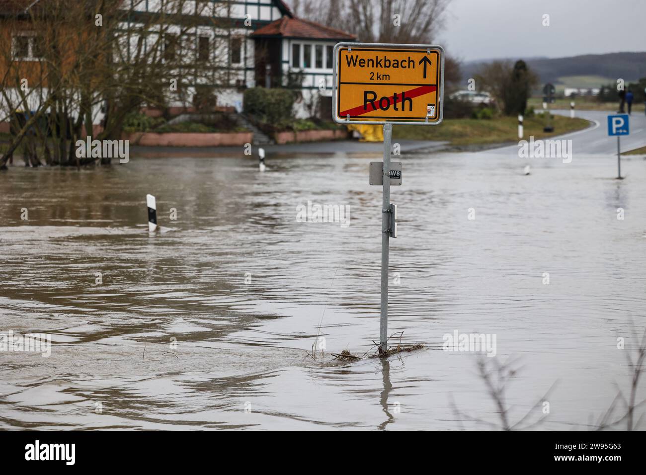 Roth, Germany. 24th Dec, 2023. The town sign of Roth protrudes from the ...